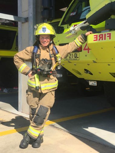 Kristin Fire Fighter full gear next to truck | Women in Aviation